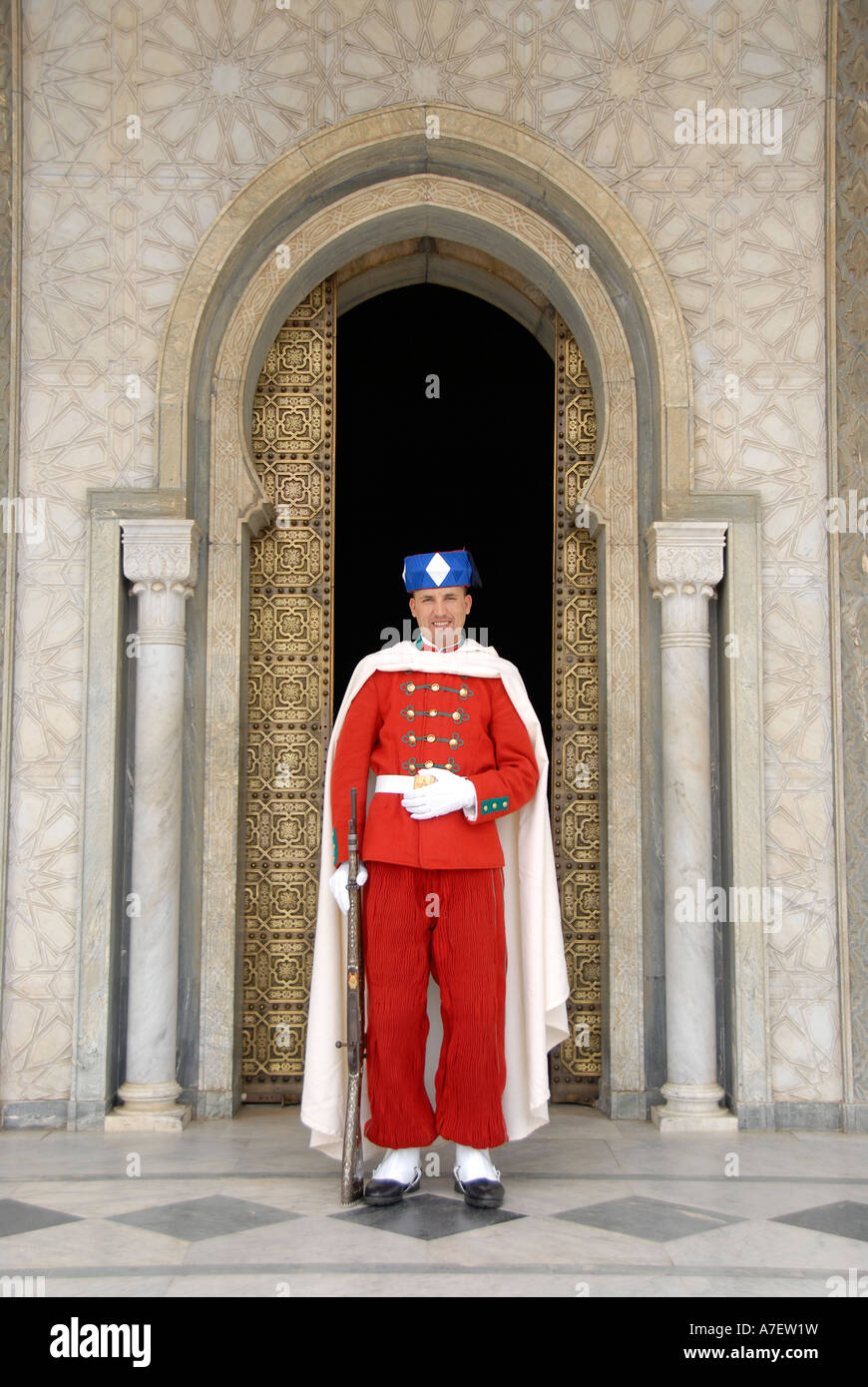 Guard in traditional uniform at gate of mausolaum Mohammed V and Hassan ...