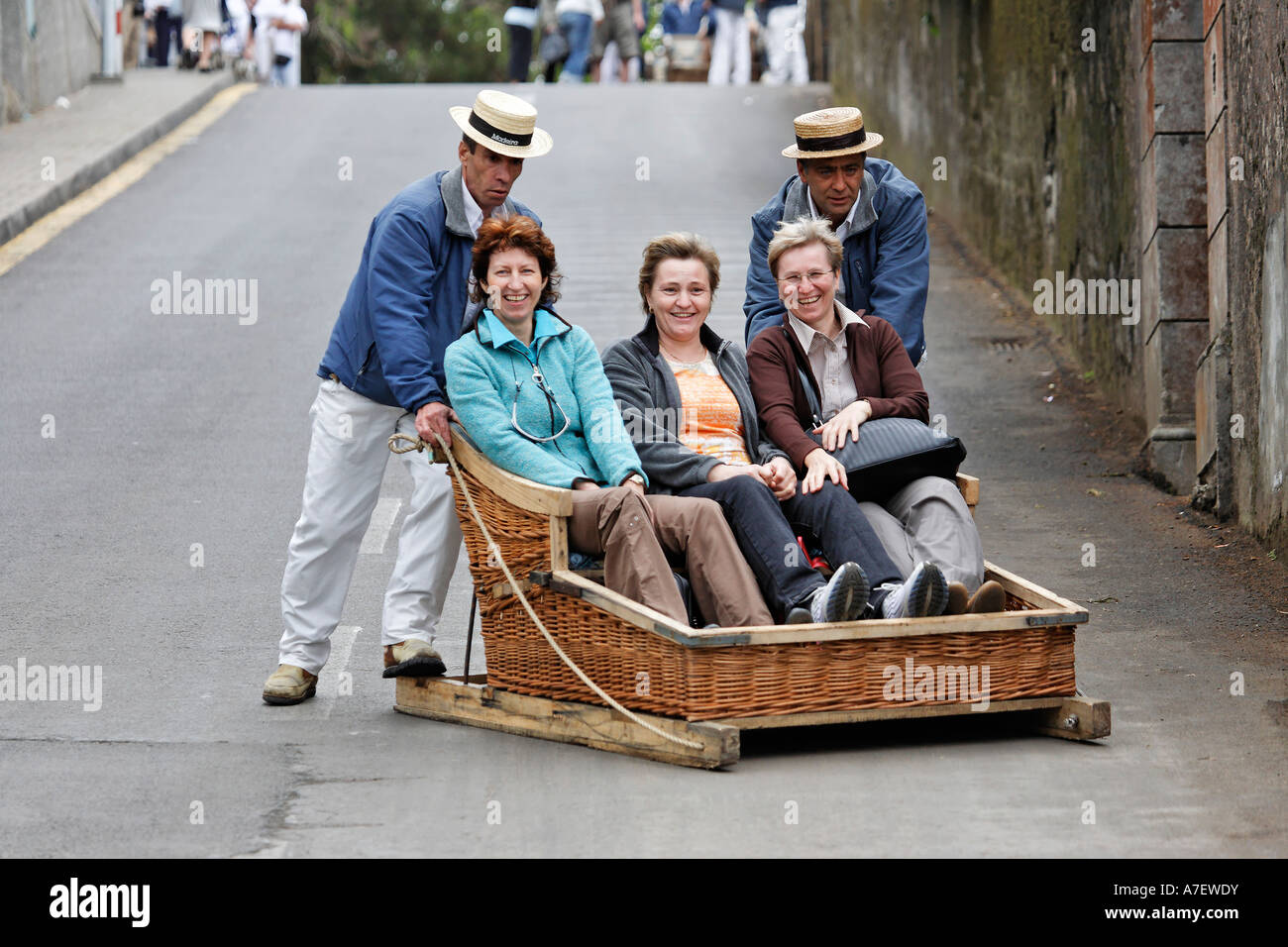 Tourist enjoy the ride with a basket sleds from Monte to Funchal, Monte ...