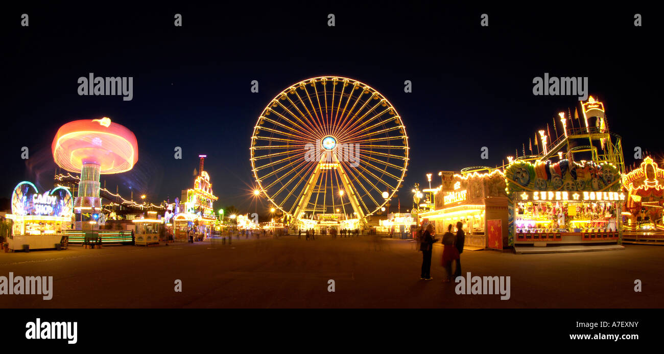 Fun fair with chairoplane and Ferris wheel Stock Photo - Alamy