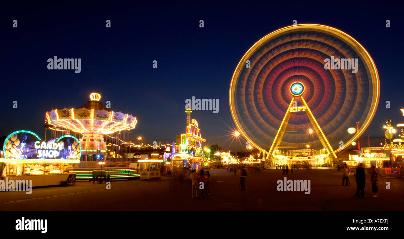 Fun fair with chairoplane and Ferris wheel Stock Photo - Alamy