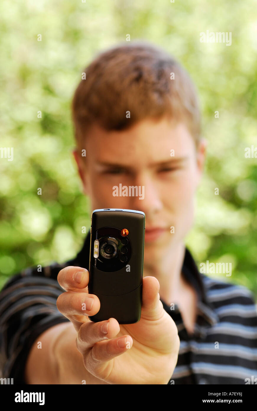 Teen taking a photo with a mobile phone Stock Photo - Alamy