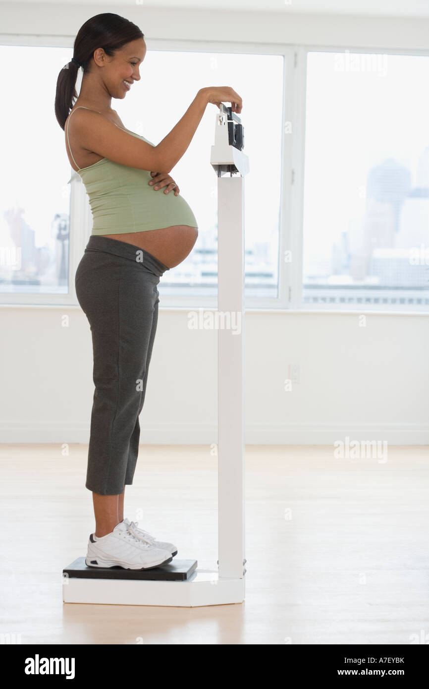 Pregnant African woman on scale Stock Photo - Alamy