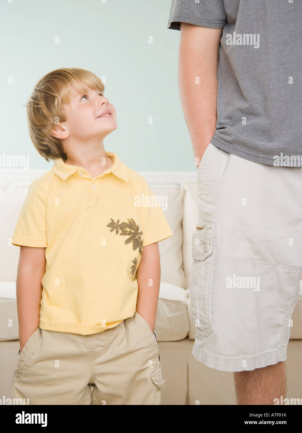 Young boy smiling up at father Stock Photo - Alamy