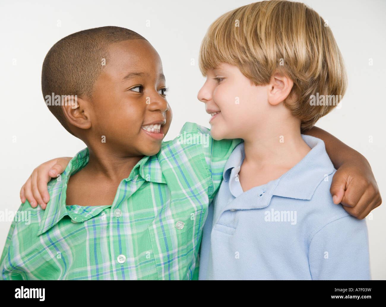 Two young boys smiling at each other Stock Photo - Alamy