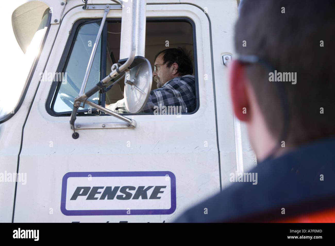 Trucks relect in window of Customs and Border Protection booth at Port ...