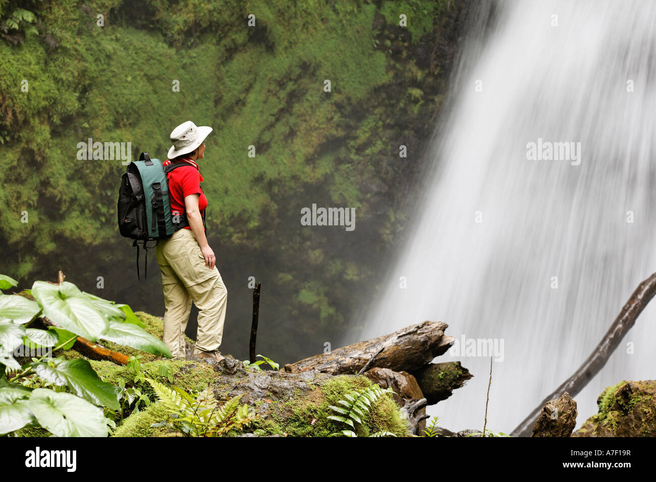 Woman at waterfall in private reserve Arenal Observatory Lodge, Arenal ...