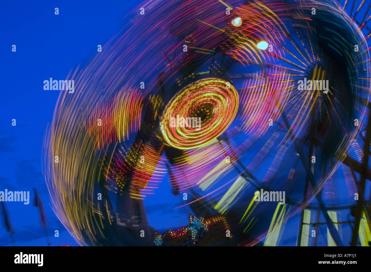 Carnival Ride At Sunset Motion Blur Stock Photo - Alamy