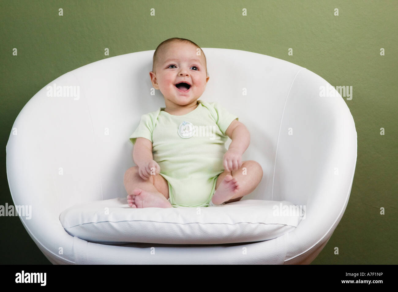 Laughing baby in chair Stock Photo - Alamy