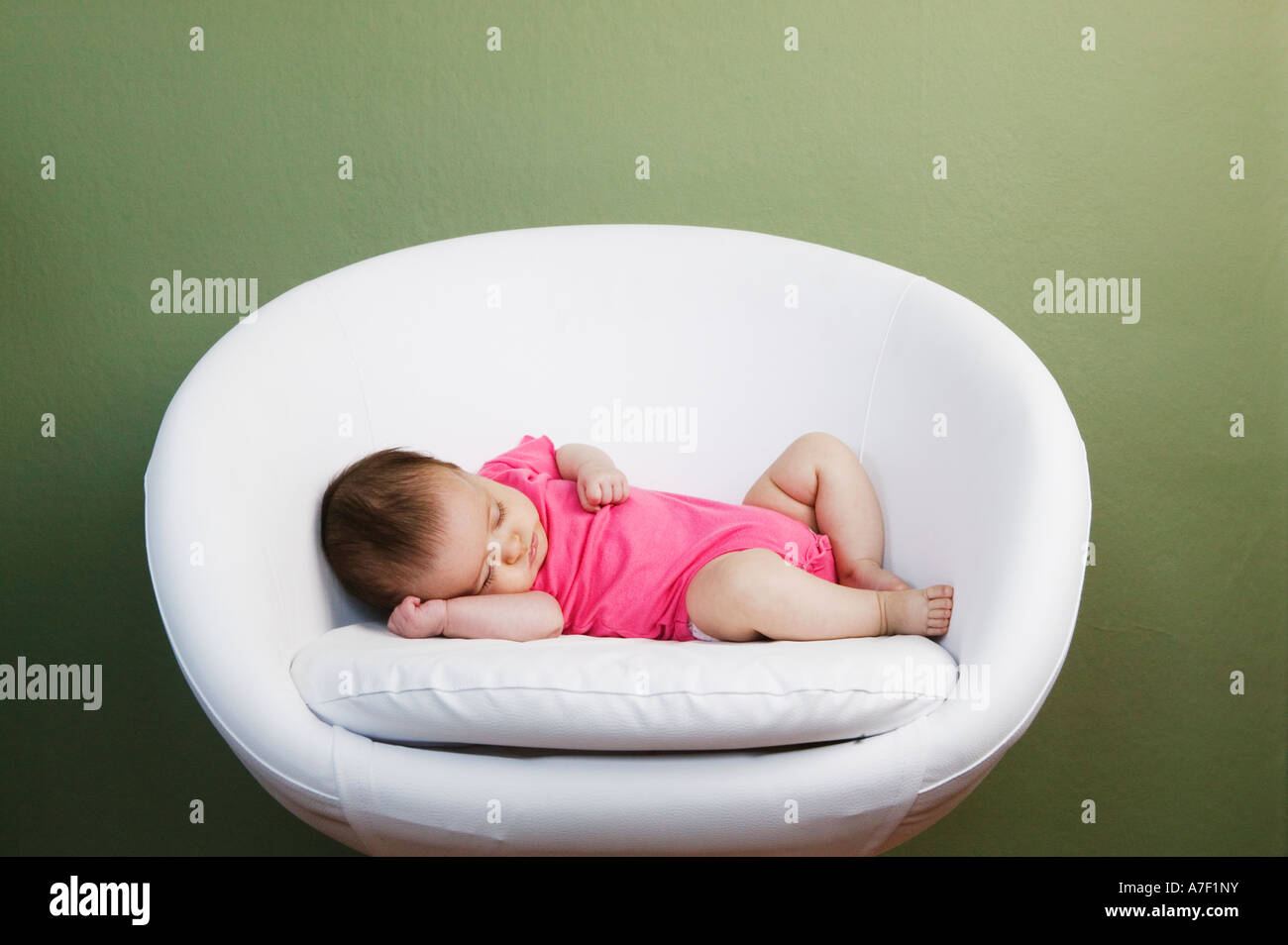 Baby sleeping on chair Stock Photo - Alamy