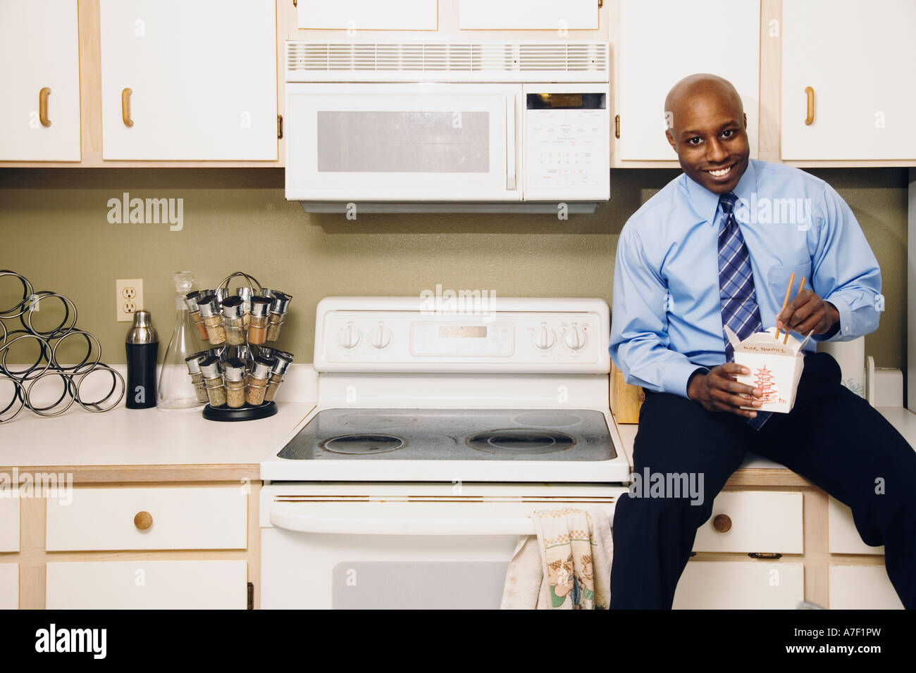 African man eating take out food in kitchen Stock Photo - Alamy