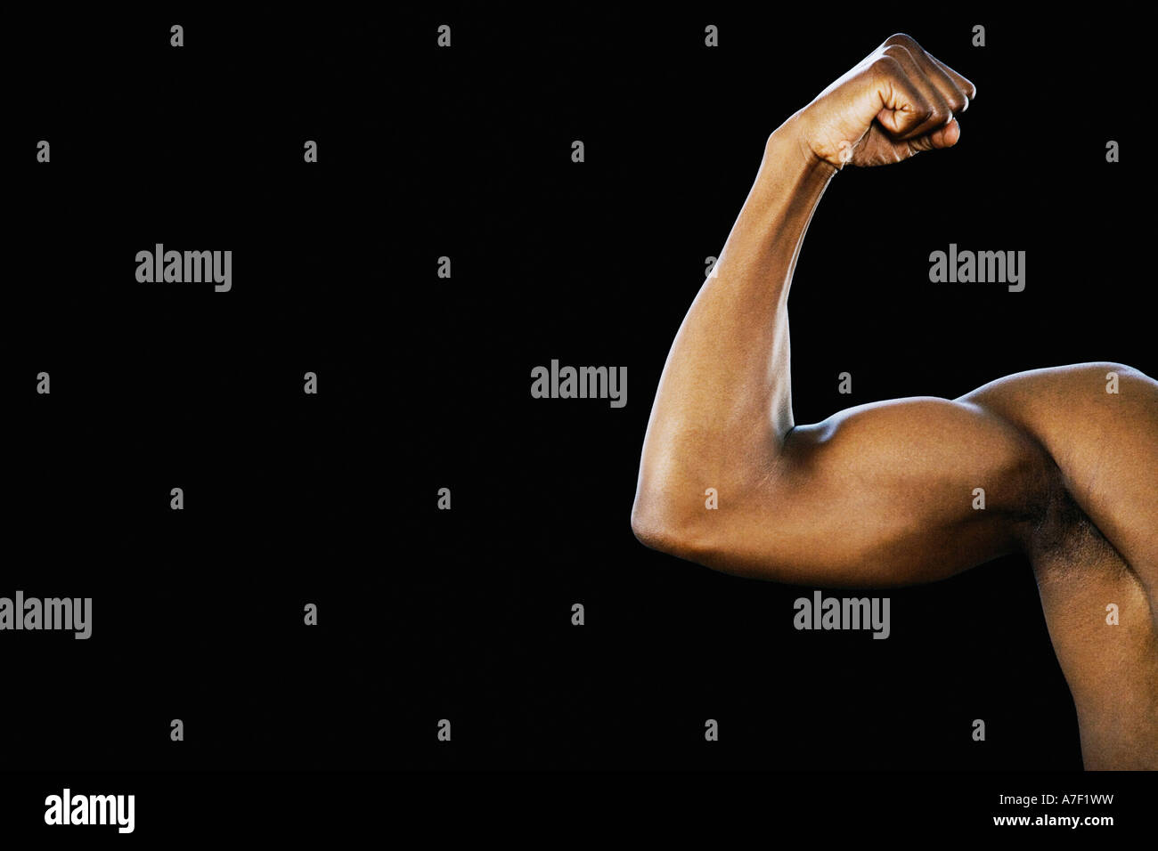 Studio shot of African man flexing biceps Stock Photo - Alamy