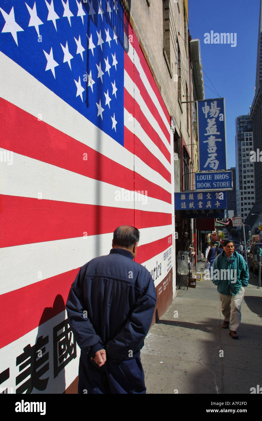 Chinese men walk past USA flag painted on wall of building in China ...