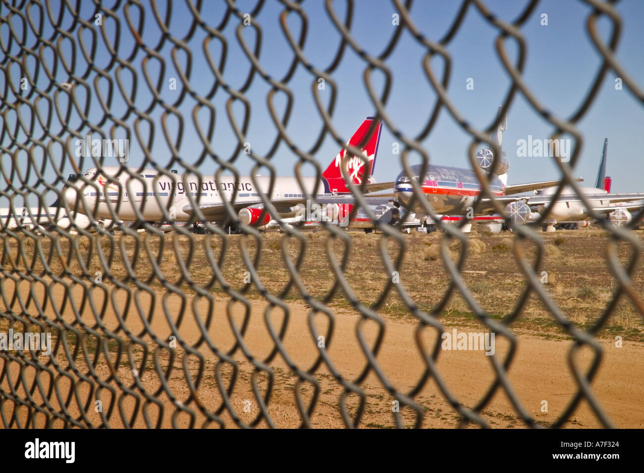 Mothballed jet aircraft behind chain link fence Mojave California Stock ...