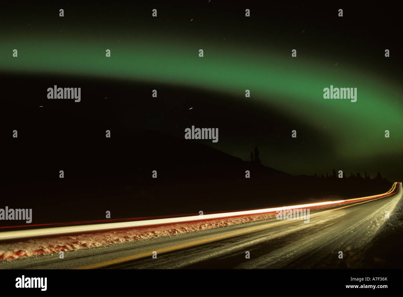 USA Alaska Northern lights Aurora Borealis over trailing car lights ...