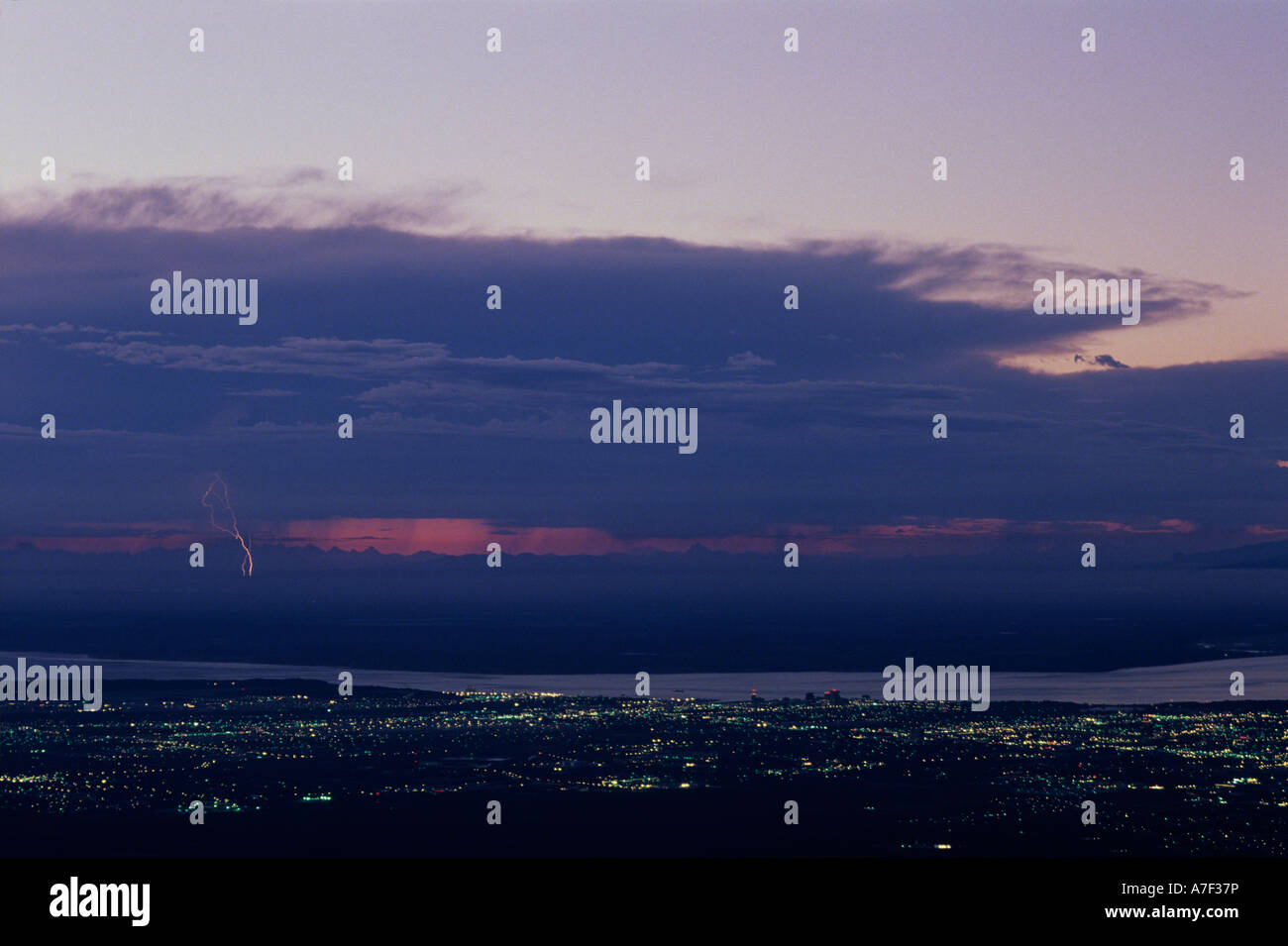 USA Alaska Summer lightning over Anchorage city skyline and Cook Inlet ...