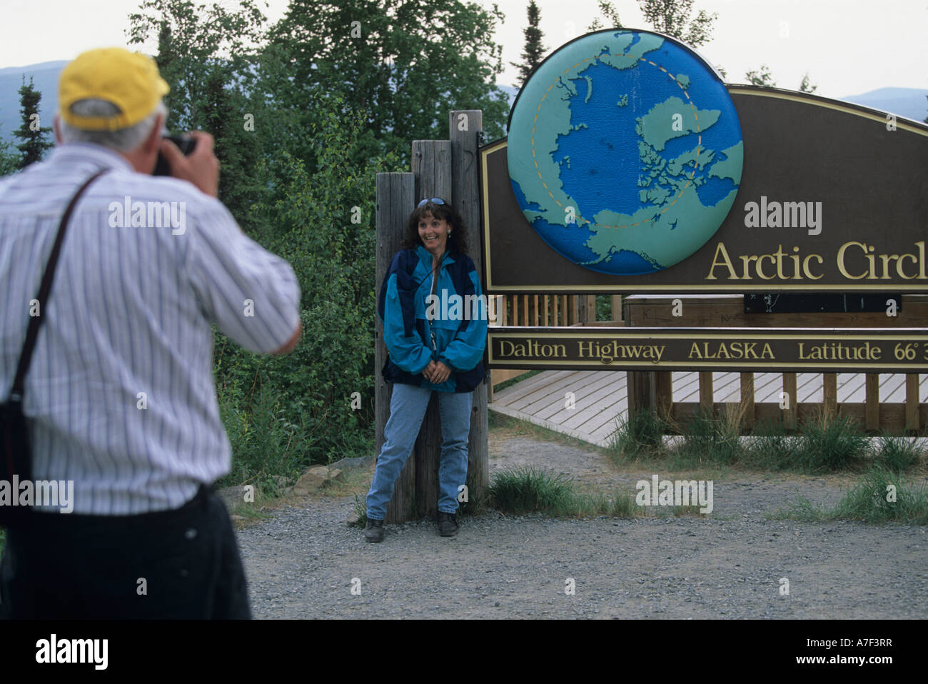 USA Alaska Tourists pose for snapshots at Arctic Circle crossing along ...