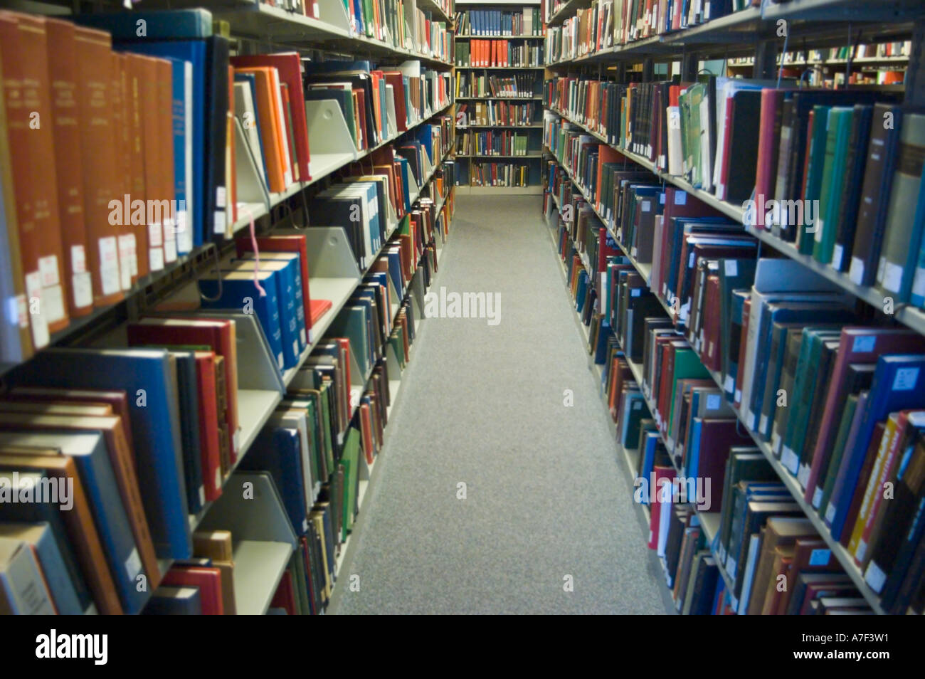 Stock photo of a long aisle between two bookshelves at a library At the ...