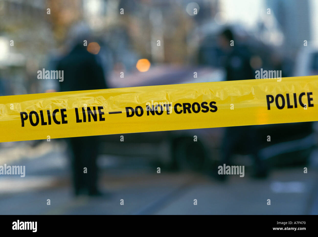 POLICE LINE DO NOT CROSS warning text on yellow barricade tape with ...