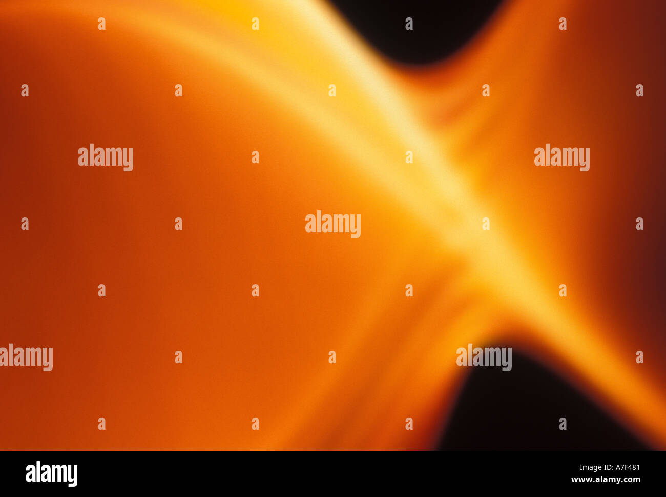 An abstract luminous light form with bright bands of orange and yellow ...