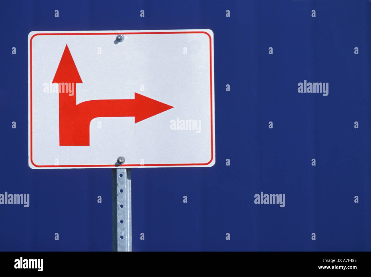 Traffic sign or road sign with red pointing arrows indicating a choice ...