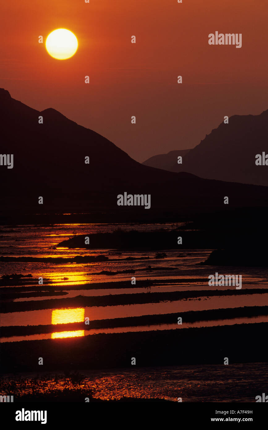 USA Alaska Setting midnight sun reflects off Atigun River in Brooks ...