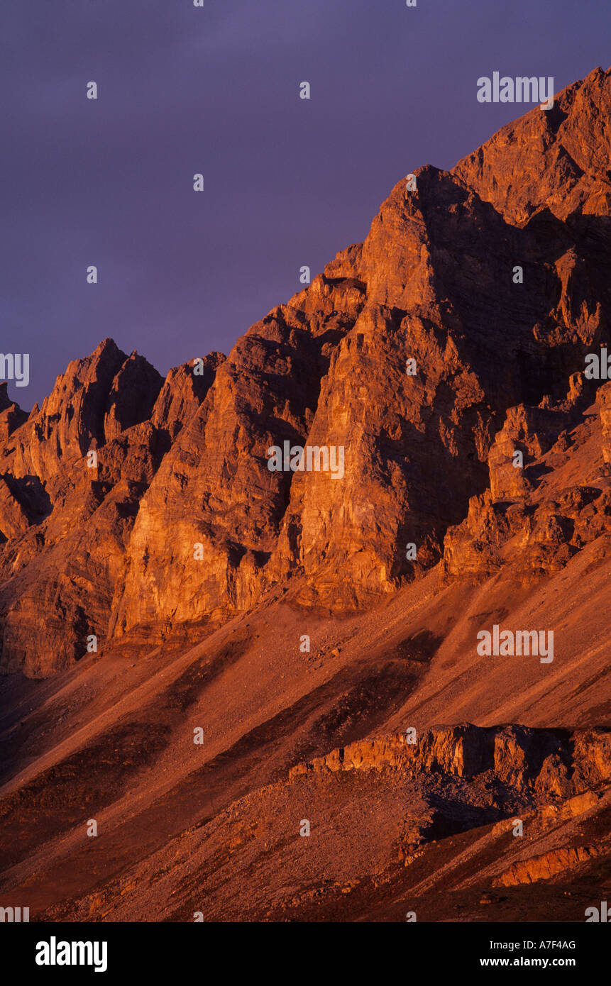 USA Alaska Setting midnight sun lights cliffs above Atigun River Canyon ...