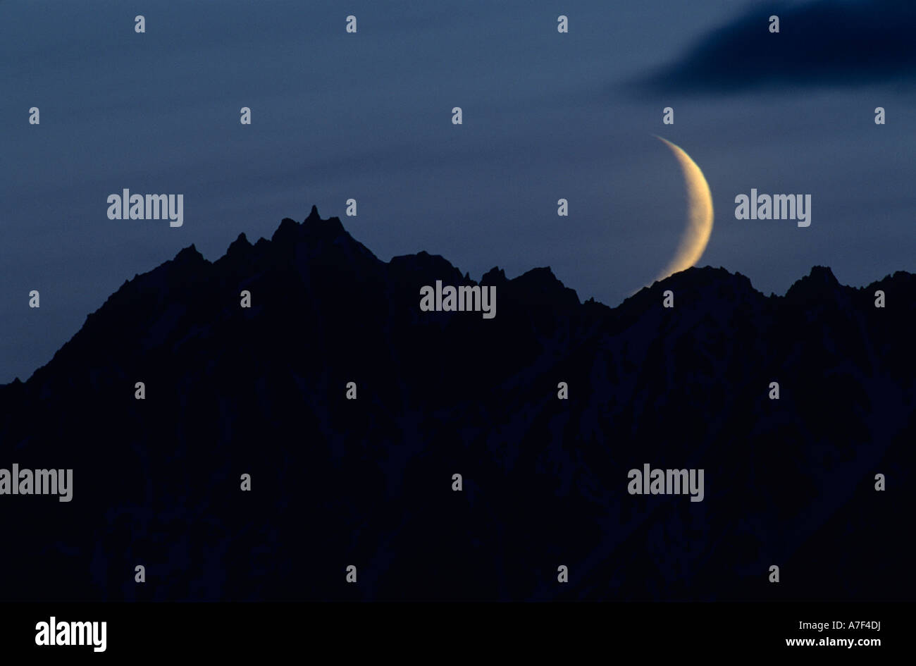 USA Alaska Denali National Park Crescent moon sets behind Alaska Range ...