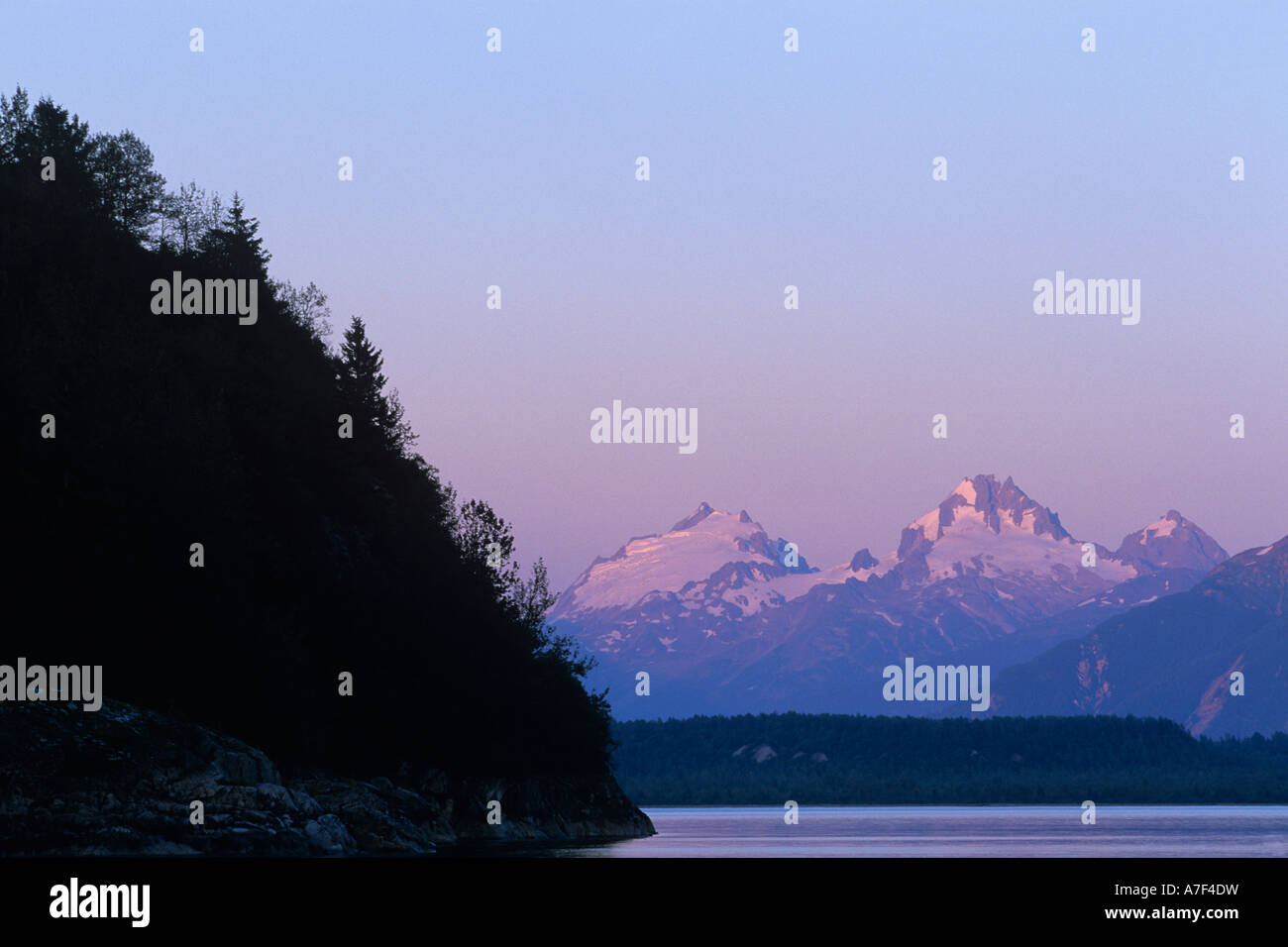 USA Alaska Glacier Bay National Park Setting sun lights glacier clad ...