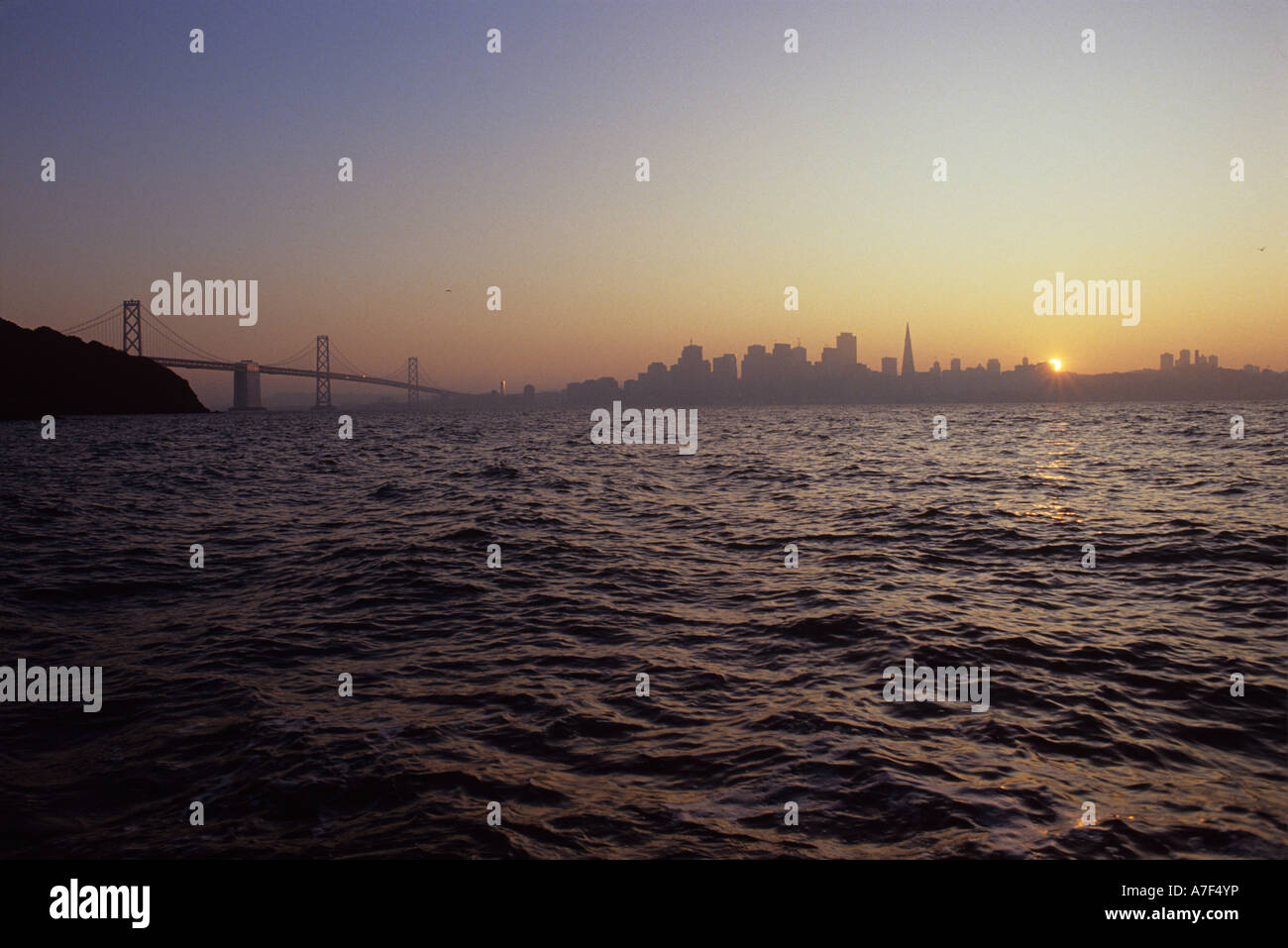 USA California San Francisco Winter sun behind city skyline and Bay ...