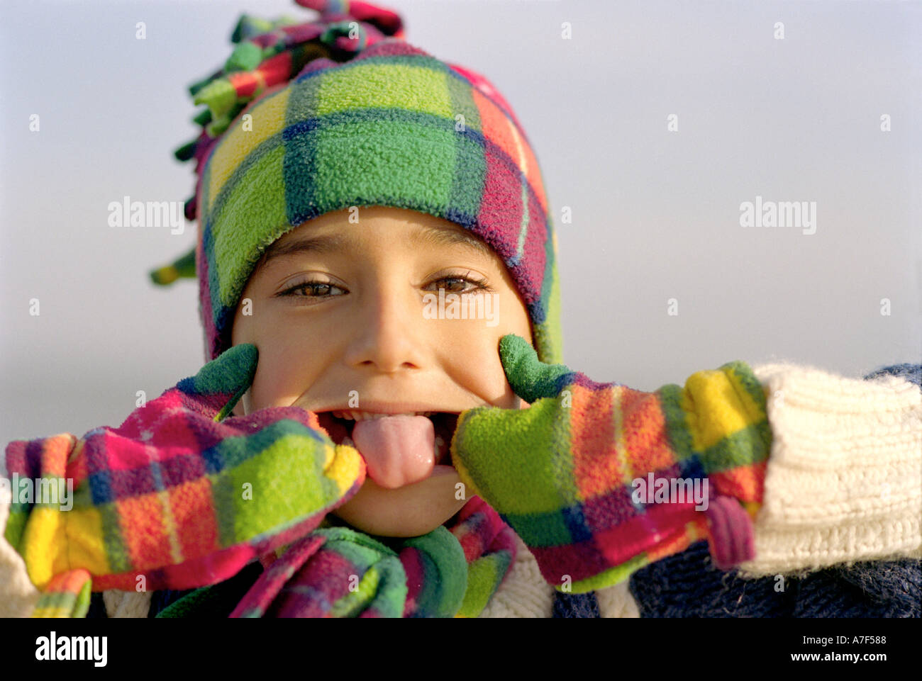 Portrait of cheeky young Indian boy pulling face at camera Stock Photo ...