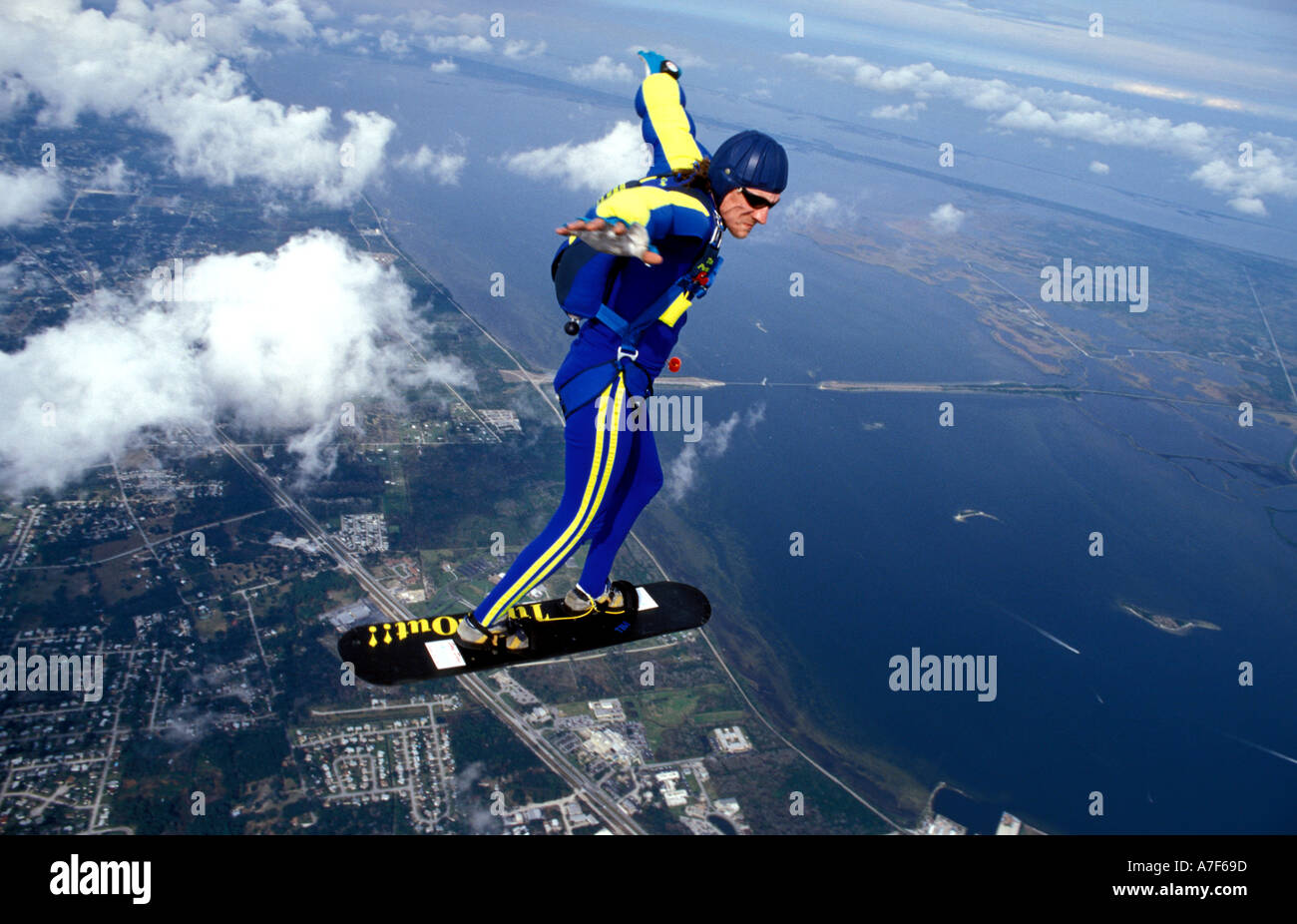Sky surfer standing up with his cheeks being pulled back with the wind ...