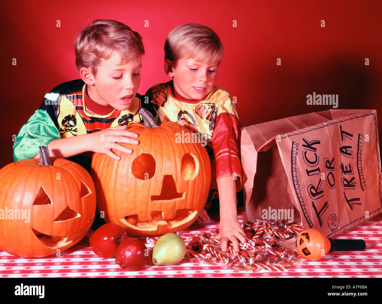 Two brothers check their goodies after Trick or Treat Halloweent visits ...