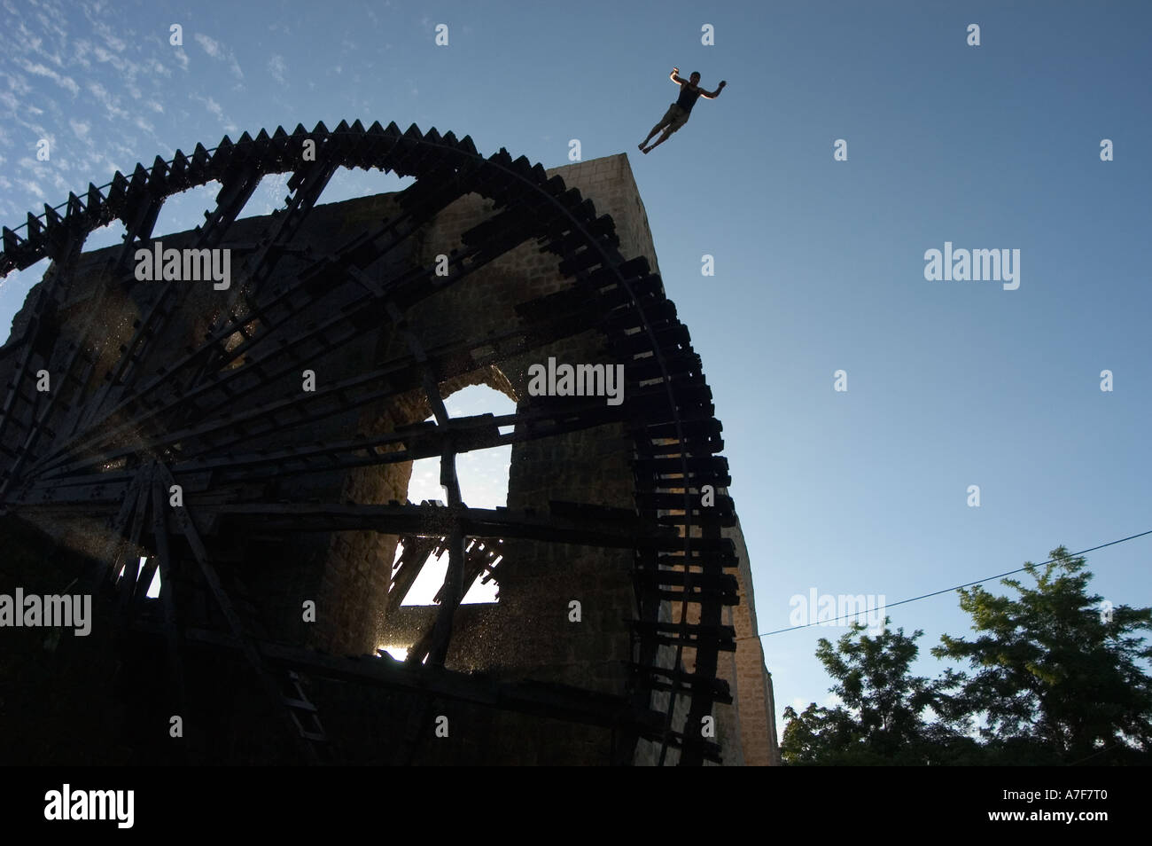 man diving off water wheel Orontes River Hama Syria Middle East Stock ...