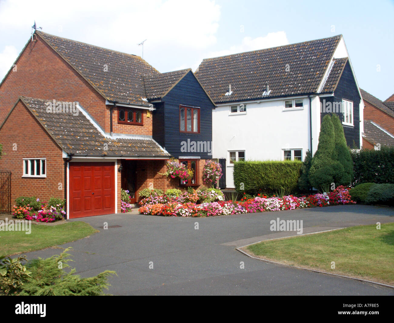 Front garden with colourful summer flower display grass lawns and ...
