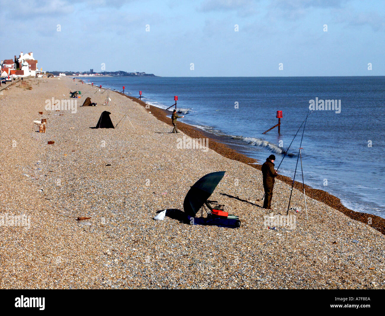 Aldeburgh pebble & shingle beach with people sea fishing the North Sea ...
