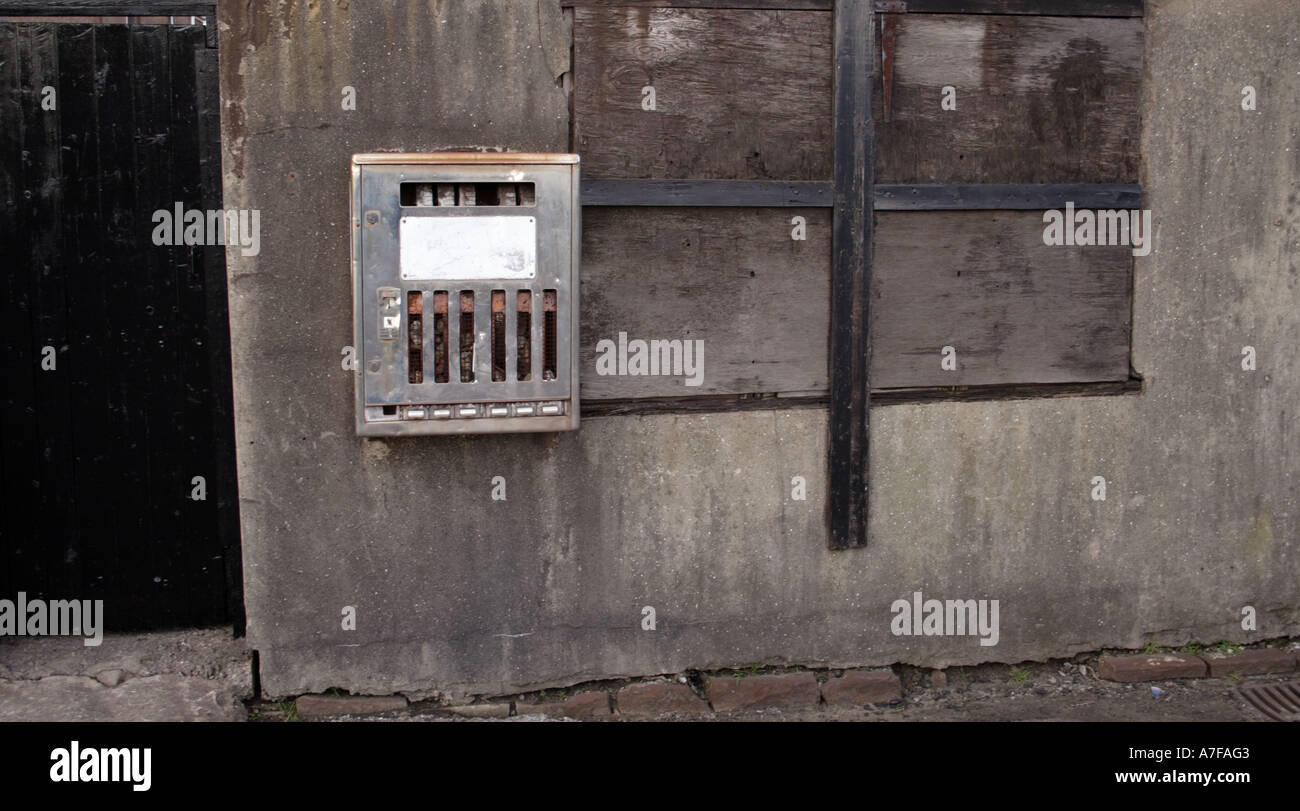 Old vending machine attached to a garage Stock Photo - Alamy