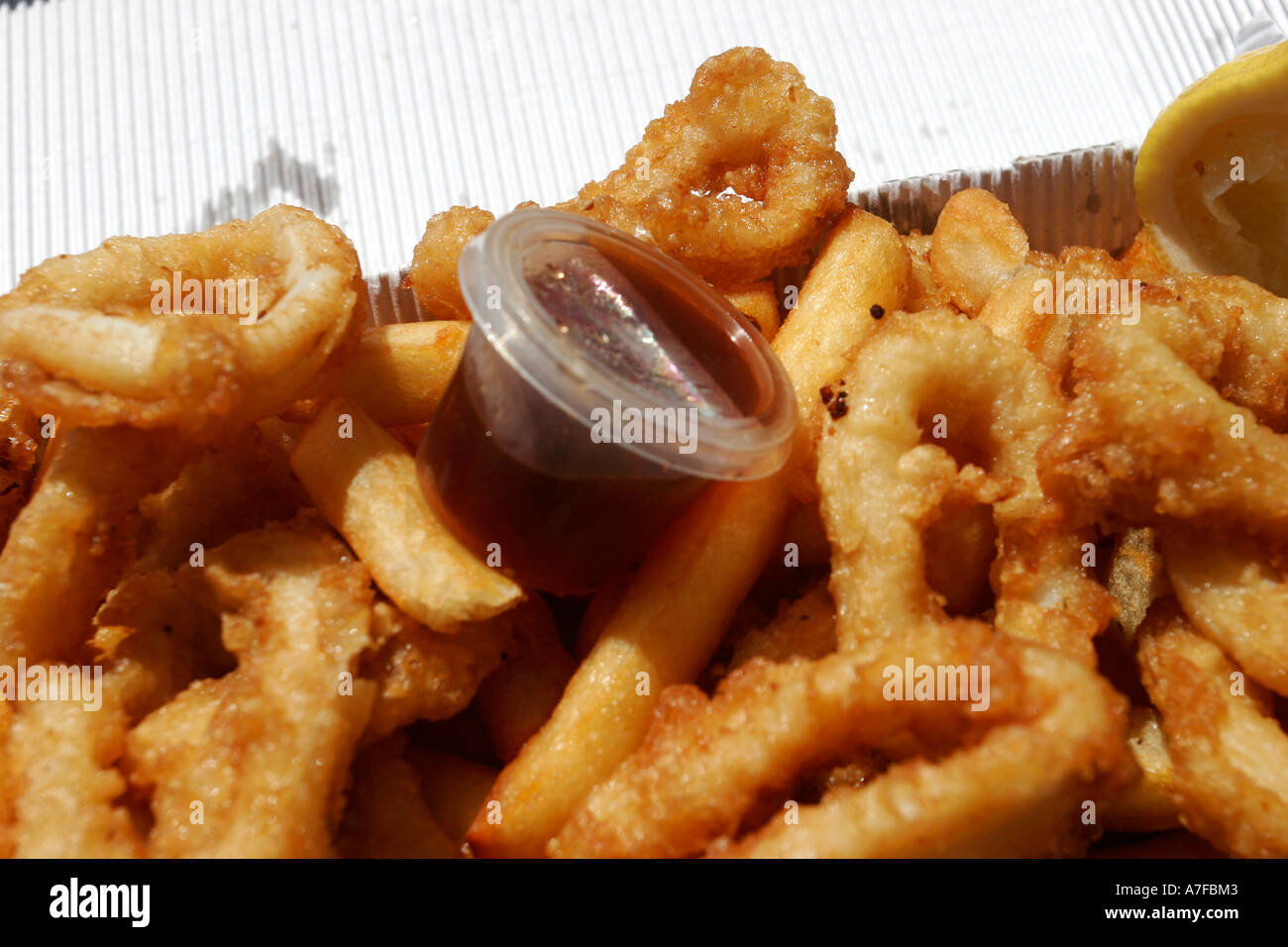 A box of calamari (squid rings) on the beach at Watsons Bay. Sydney NSW ...