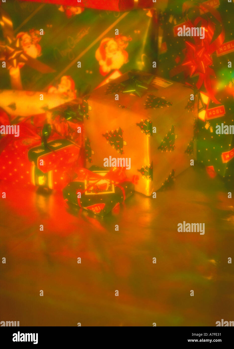 Christmas gifts wrapped in colorful wrapping paper sitting under a ...