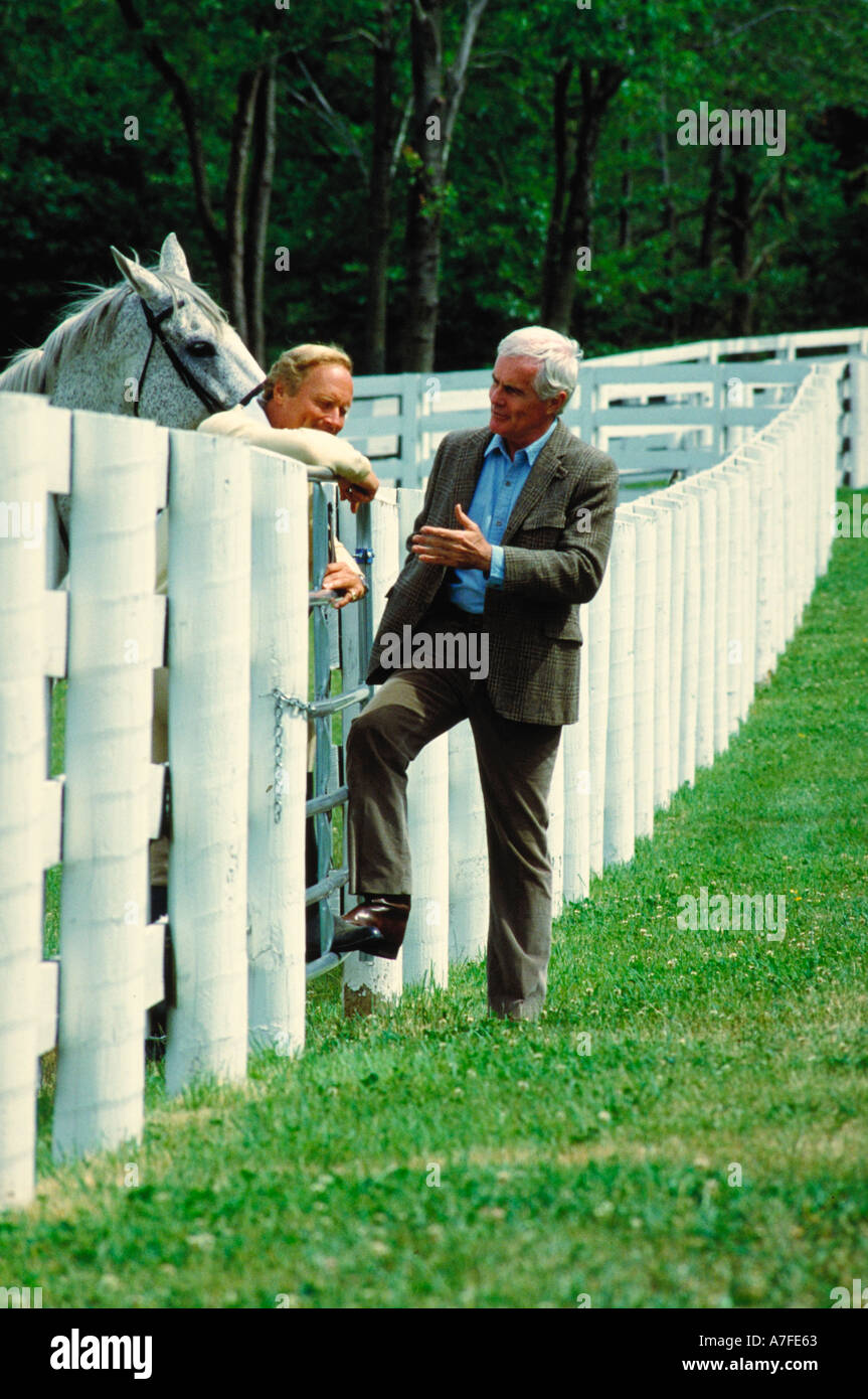 Talking over fence hi-res stock photography and images - Alamy