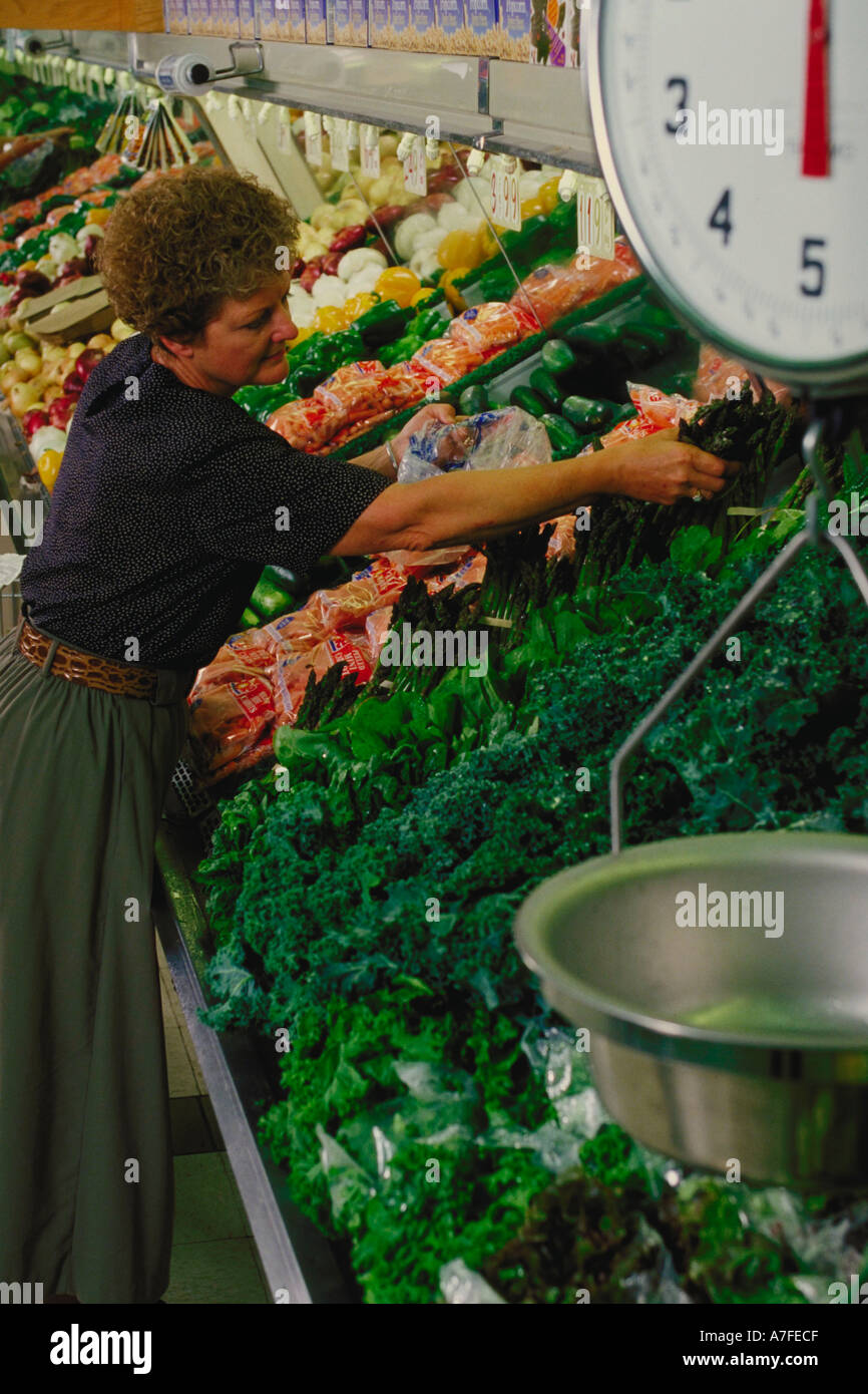 Woman picking out produce at supermarket MR Stock Photo - Alamy