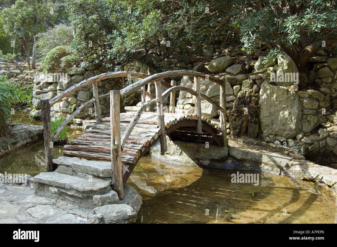 Wooden bridge over pond in Japanese garden Stock Photo - Alamy