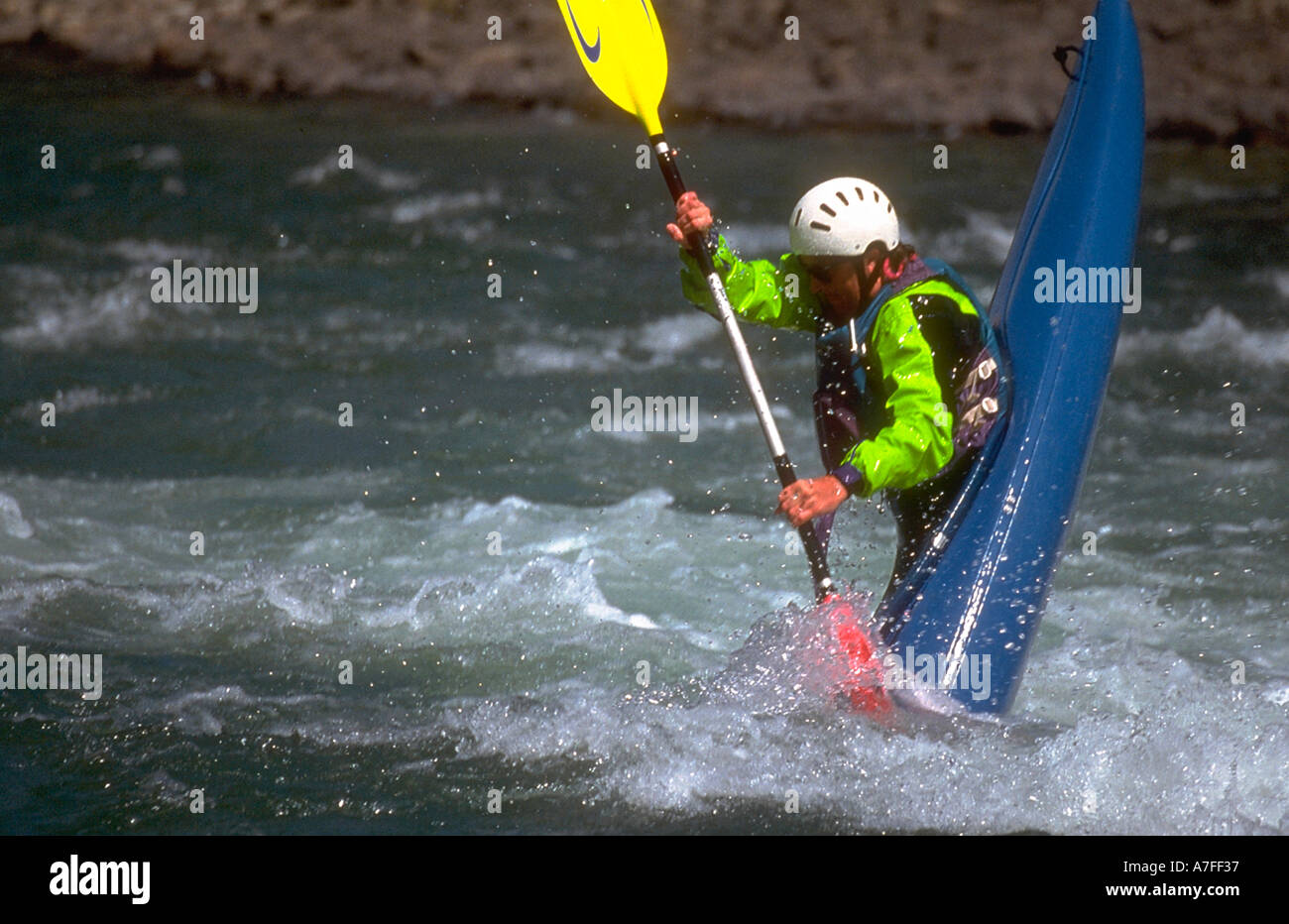 Kayaker in white water with kayak in vertical position in the water ...