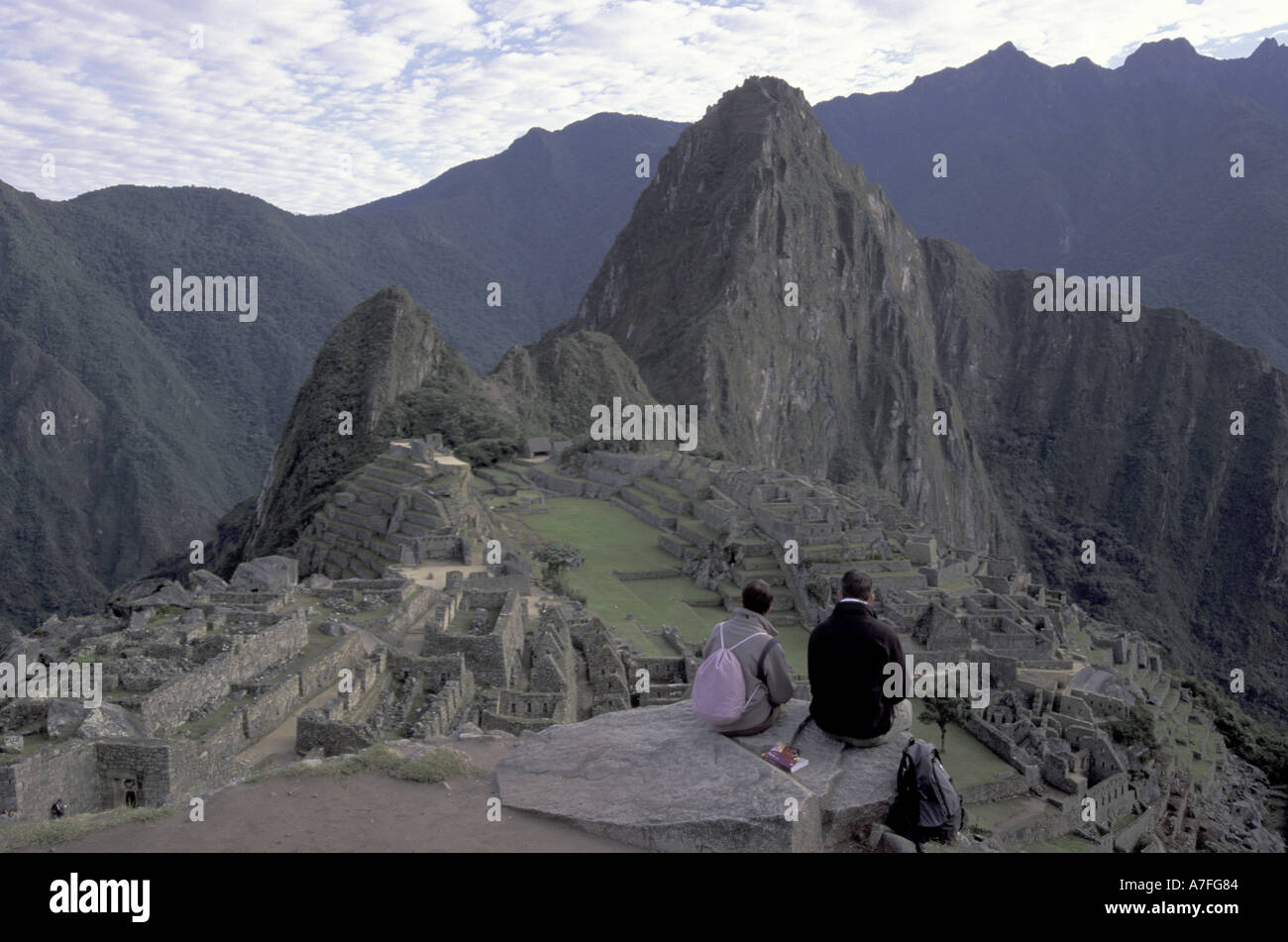 SA, Peru, Machu Picchu Couple share quiet moment overlooking ruins of ...