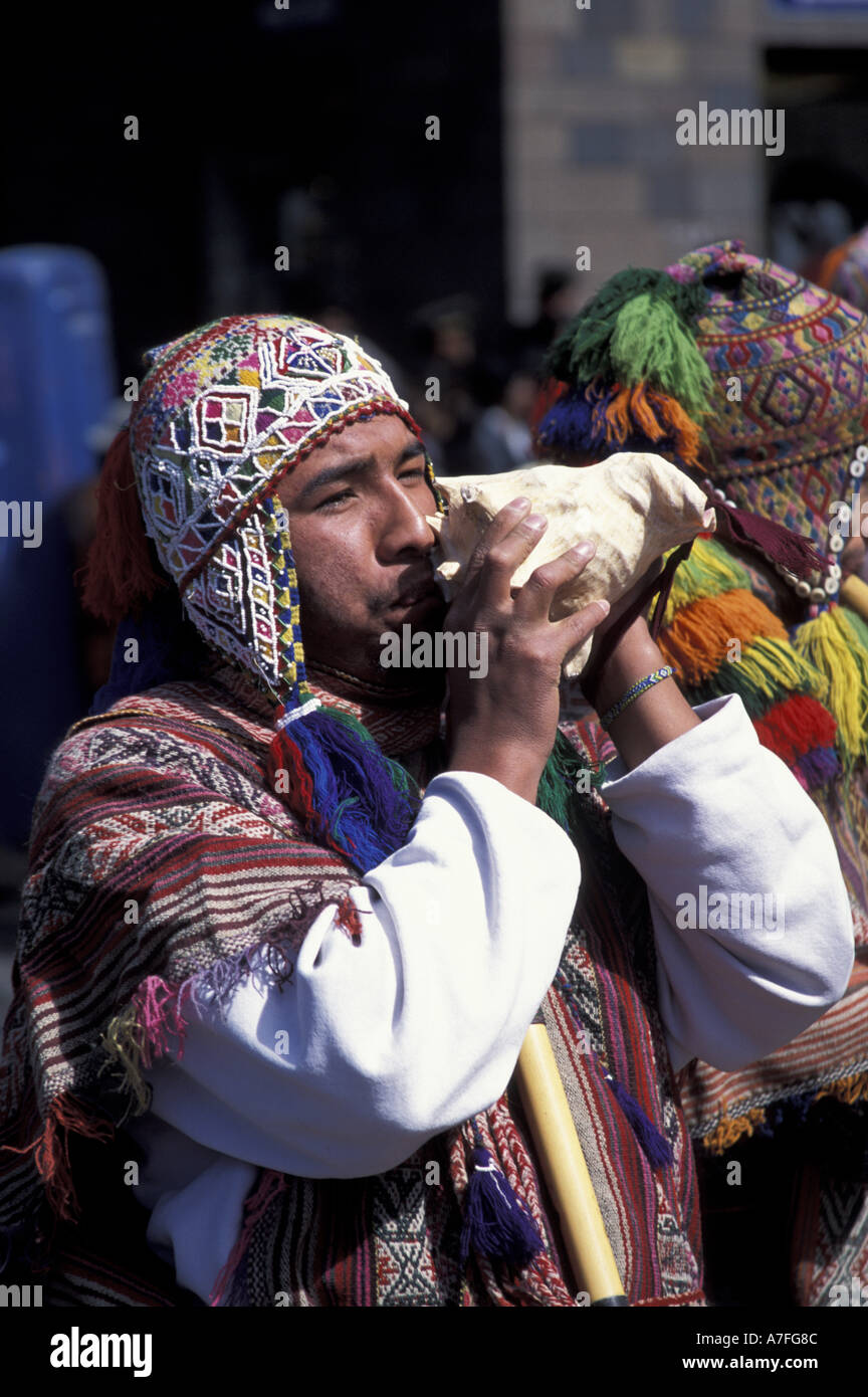 SA, Peru, Cusco, a boy blowing conch shell horn, traditional dress ...