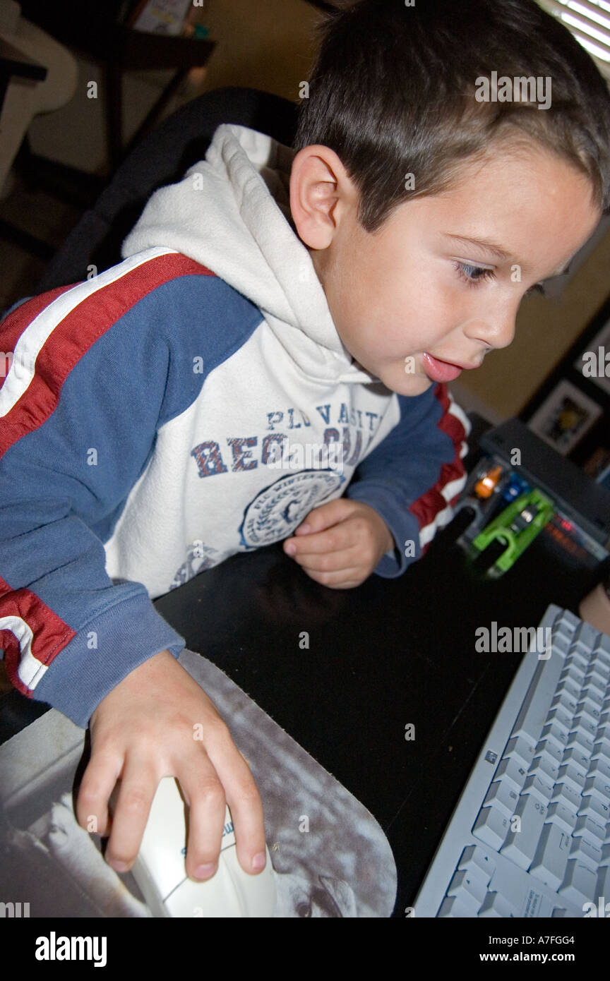 Boy on computer operating mouse Stock Photo - Alamy