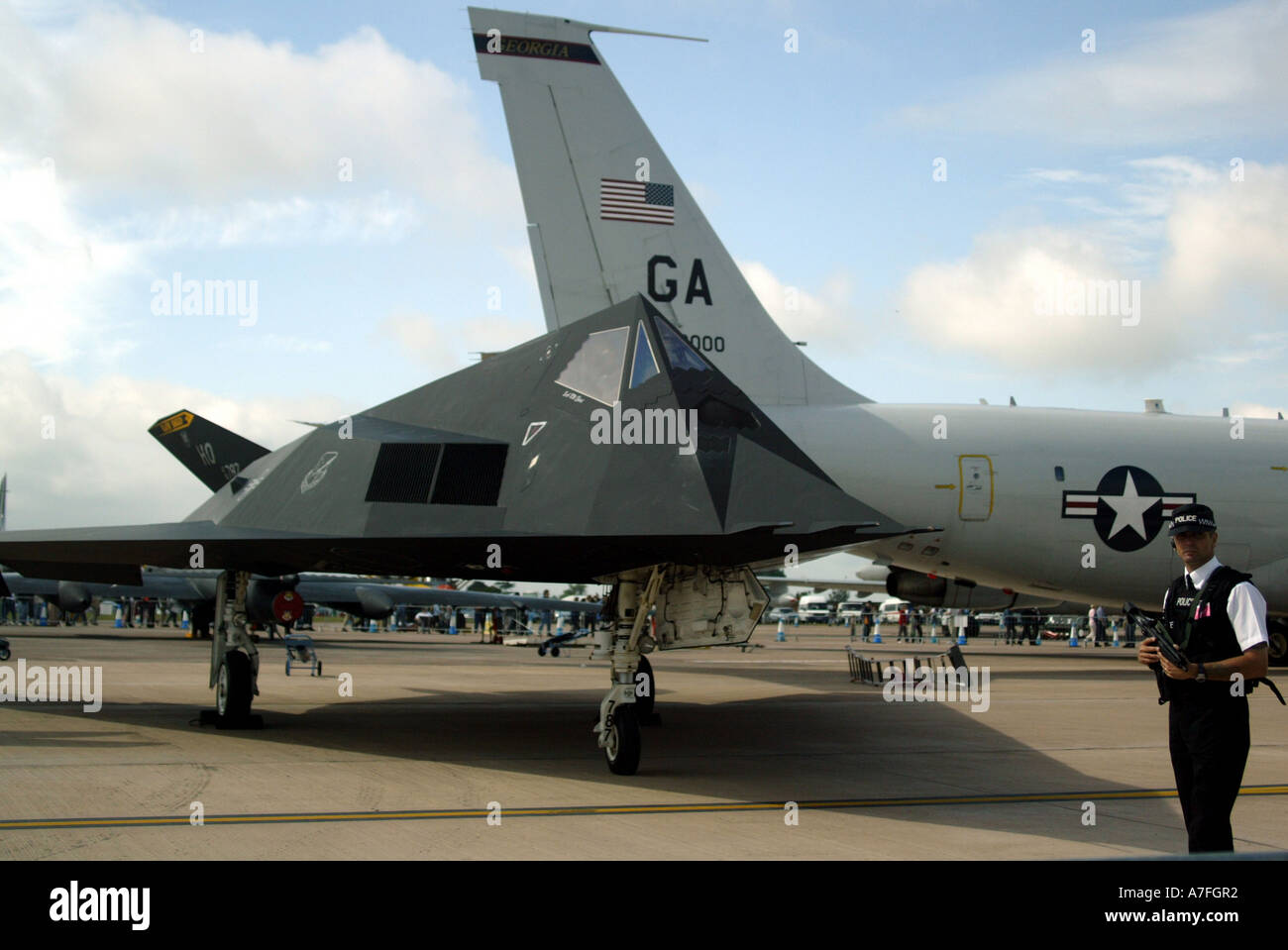 A armed British Policeman guards a USAF F-117A Stealth Bomber at an ...