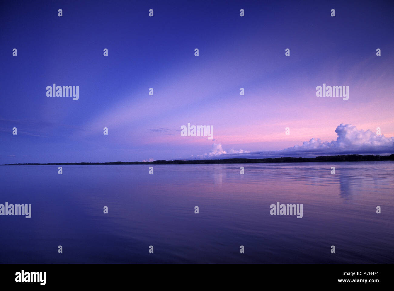 SA, Peru, Sunset over the Amazon River and the Peruvian rainforest ...