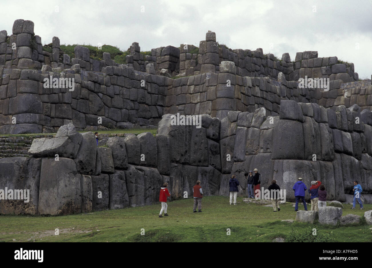 SA, Peru, Cuzco. Visitors at the Inca ruins of Sacsayhuaman Stock Photo ...