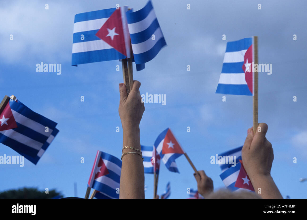 Cuba, Havana.Cubans wave paper flags at a MayDay rally as Fidel Castro ...