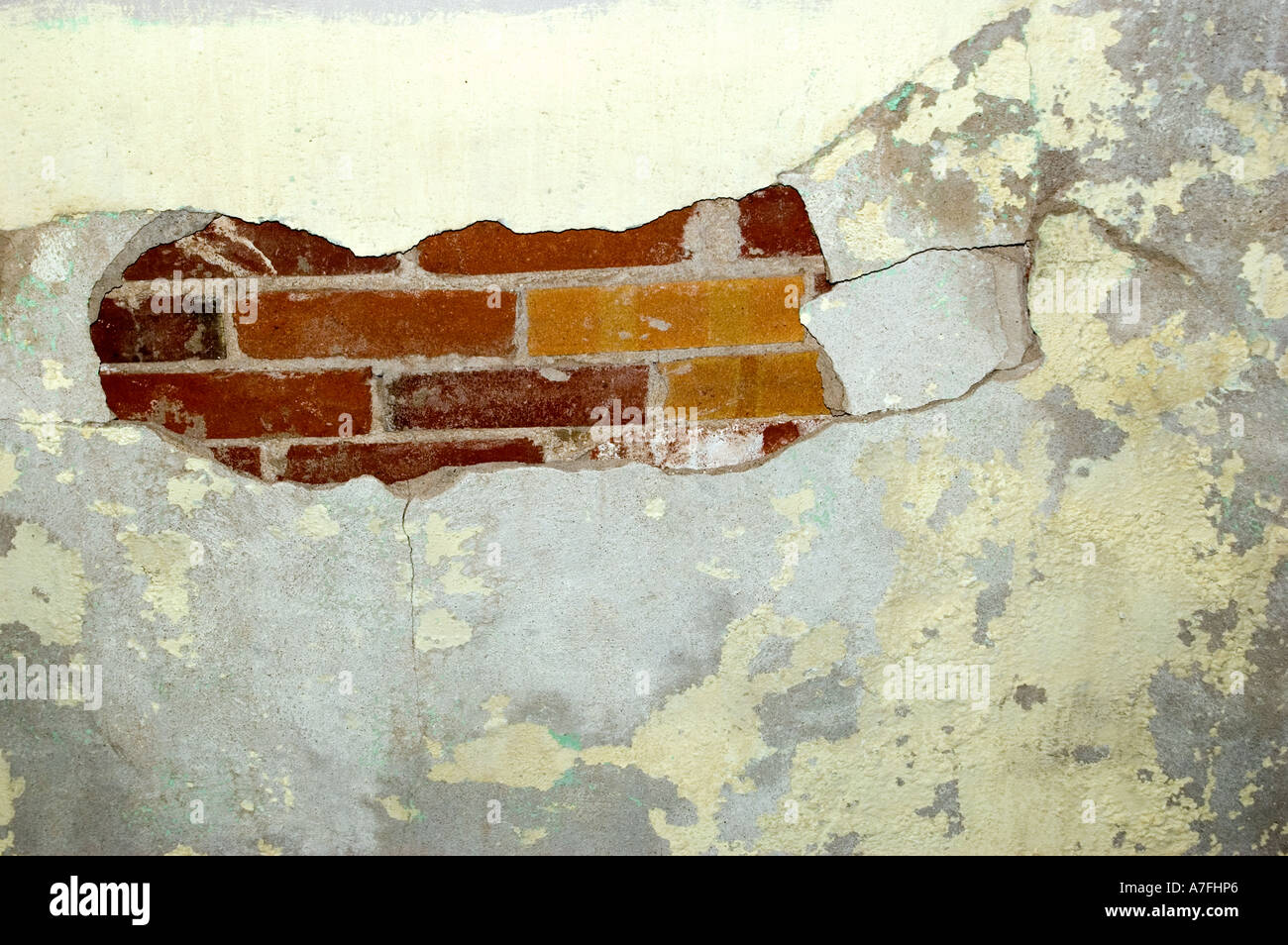 Plaster chipping off brick building Stock Photo - Alamy